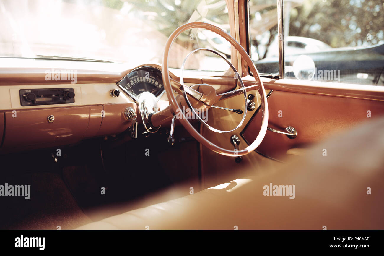 Interior of a classic vintage car. Retro style steering wheel with ...