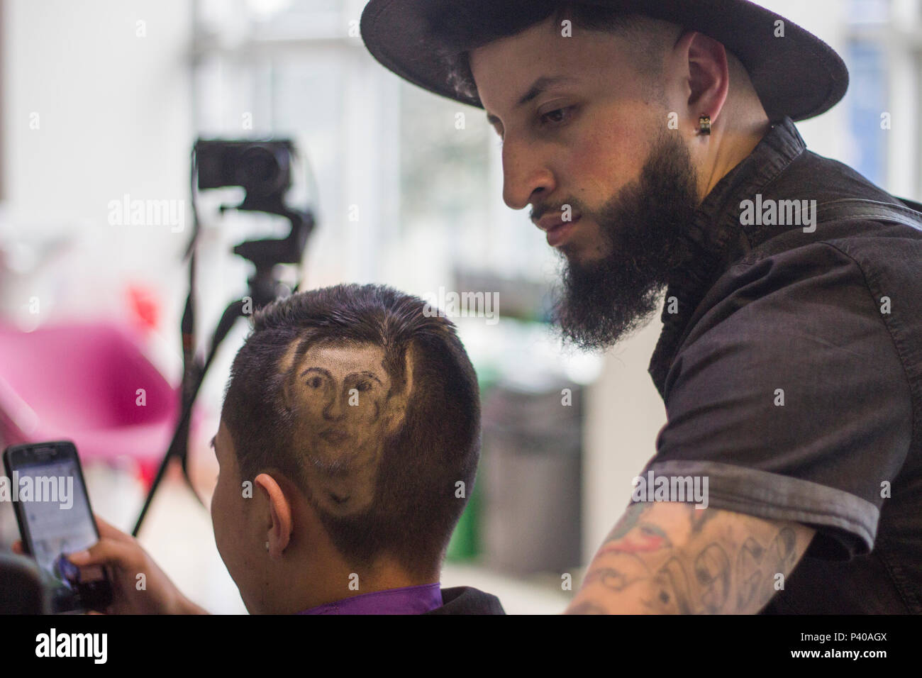 A Colombian barber sculpting the faces of football players in the heads ...