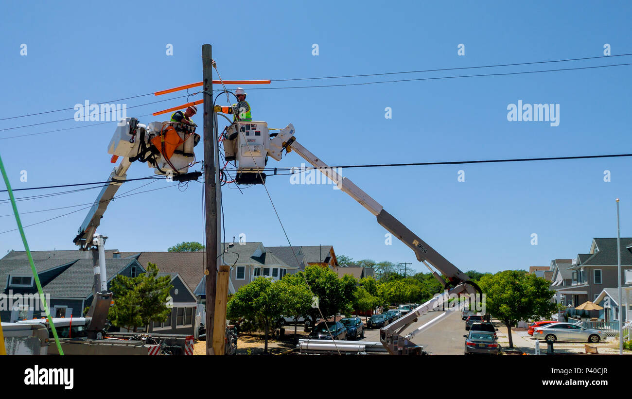 Sayreville NJ - June 15, 2018: Workers repair telecommunication cable after heavy wind storm Two ...