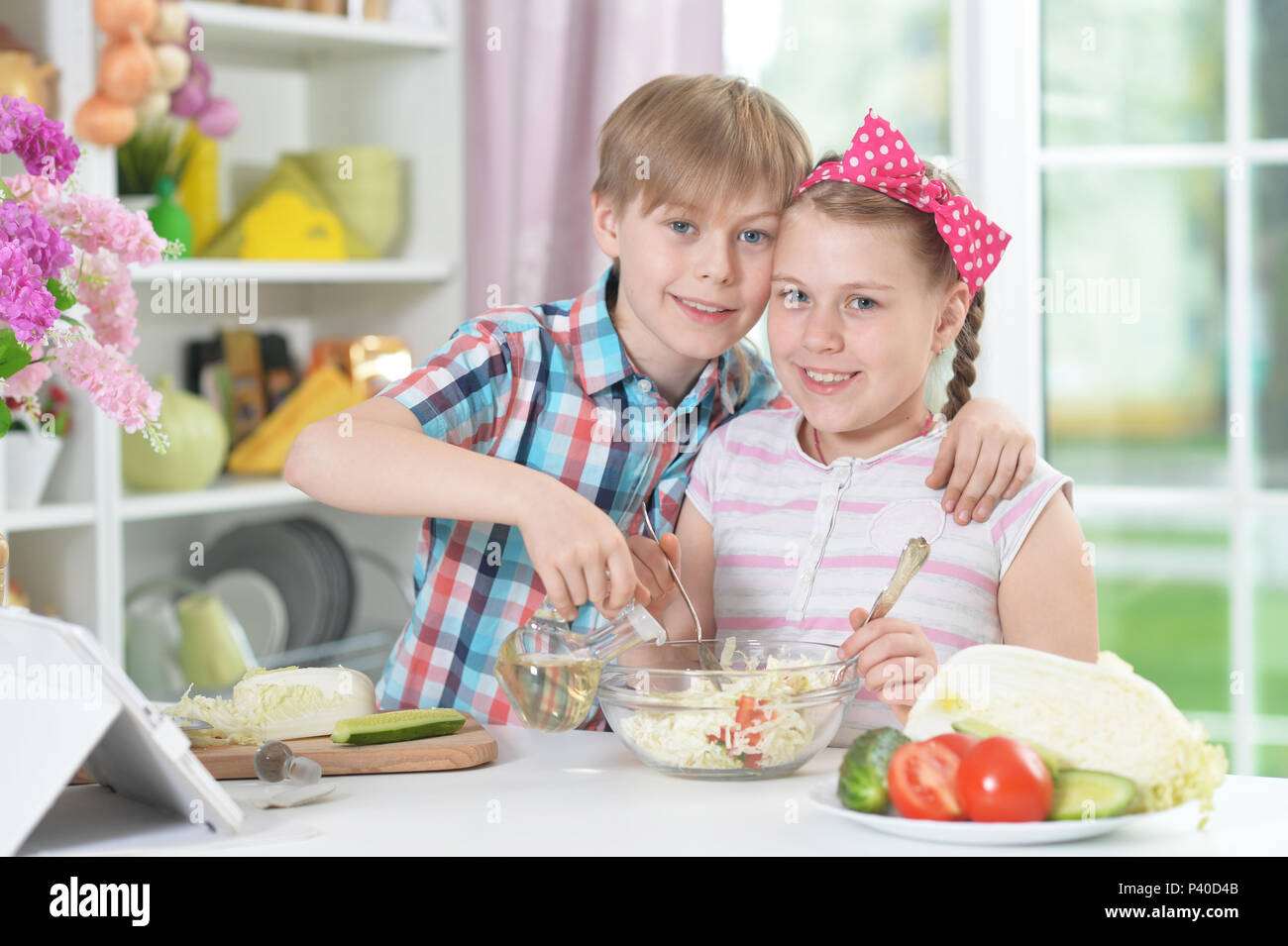 Cute brother and sister cooking together Stock Photo - Alamy