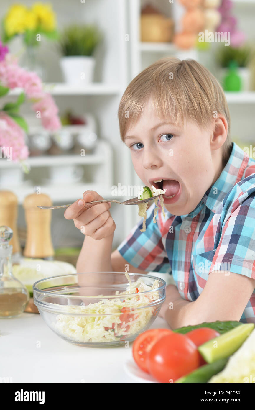 Cute boy eating healthy salad Stock Photo - Alamy