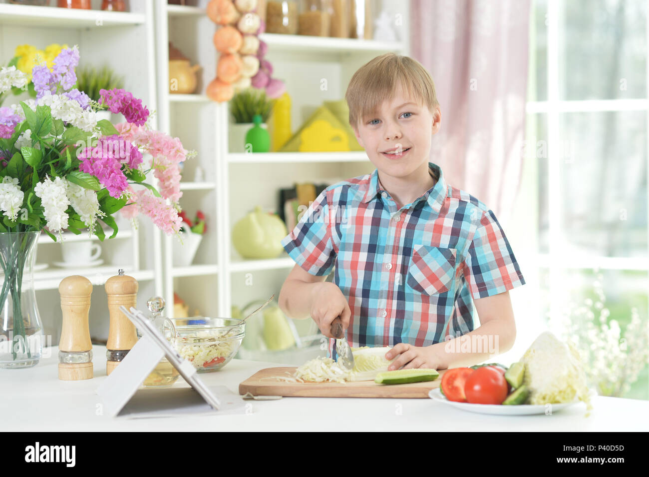 Cute little boy making dinner Stock Photo - Alamy