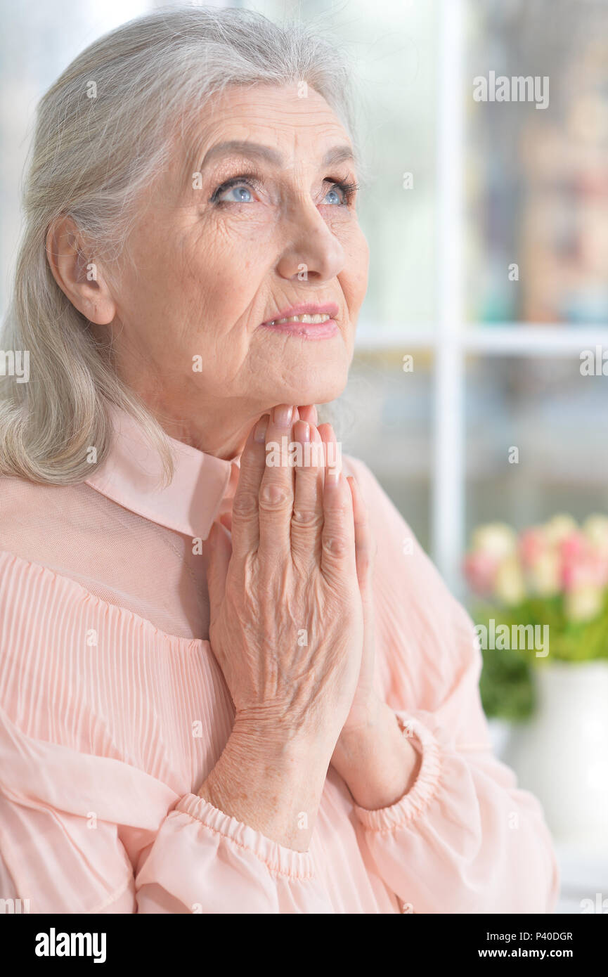 Elderly lady praying hi-res stock photography and images - Alamy