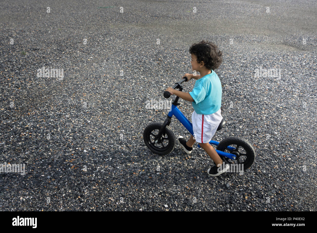 Asian kid first day play balance bike. Little boy learning to ride with ...