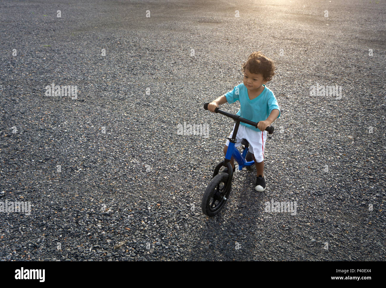 Asian kid first day play balance bike. Little boy learning to ride with ...