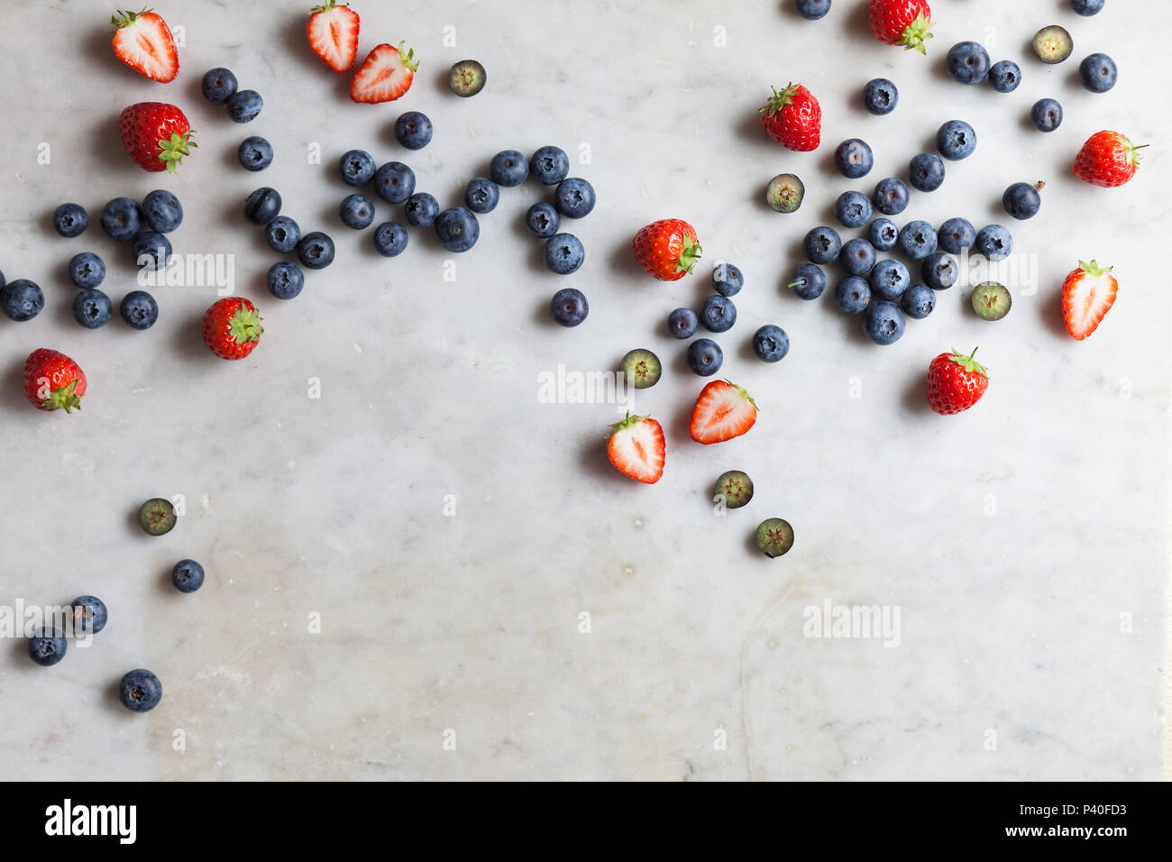 Summer fruits scattered over marble worktop Stock Photo - Alamy