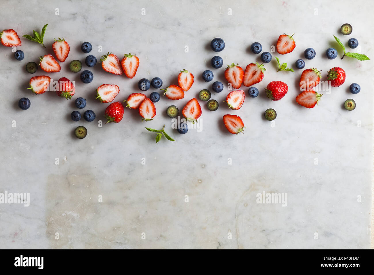 Summer fruits scattered over marble worktop Stock Photo - Alamy