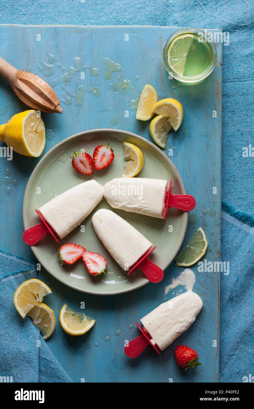 Creamy lemon ice lollies on blue background Stock Photo - Alamy