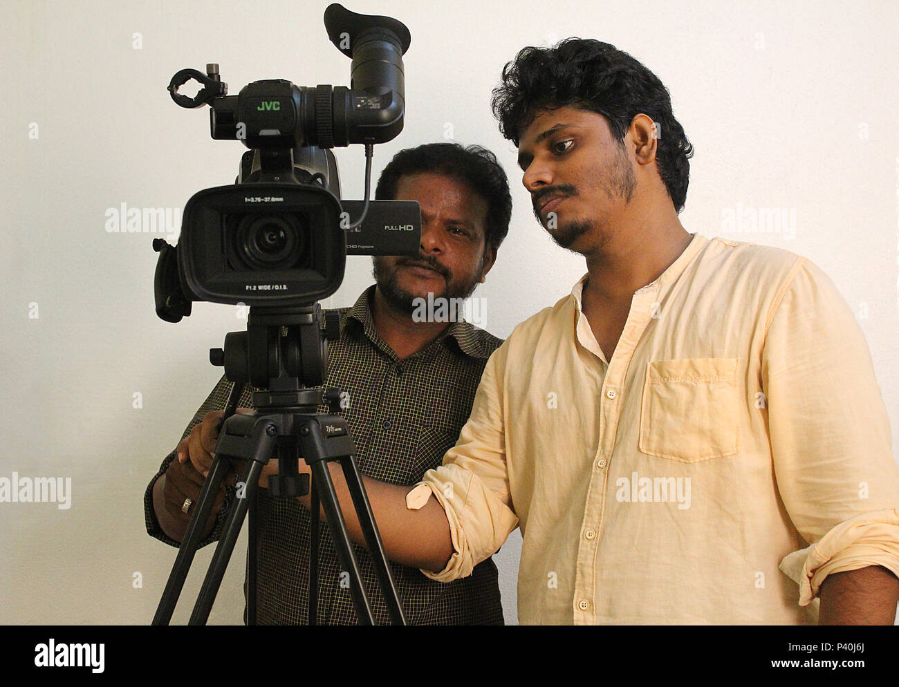Behind the scene. Cameraman and director shooting the film scene with ...
