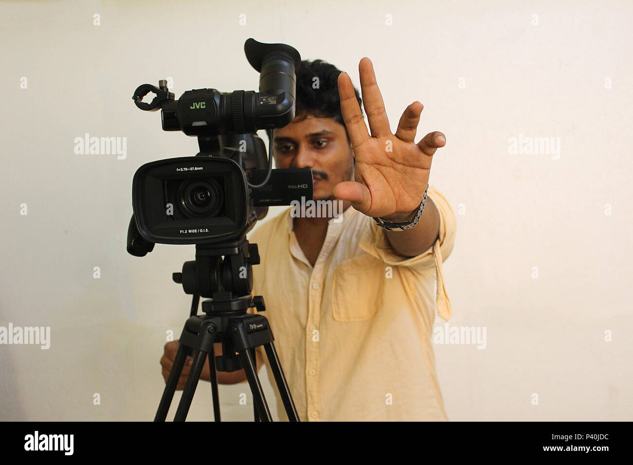 Professional cameraman shooting a video in studio Stock Photo - Alamy
