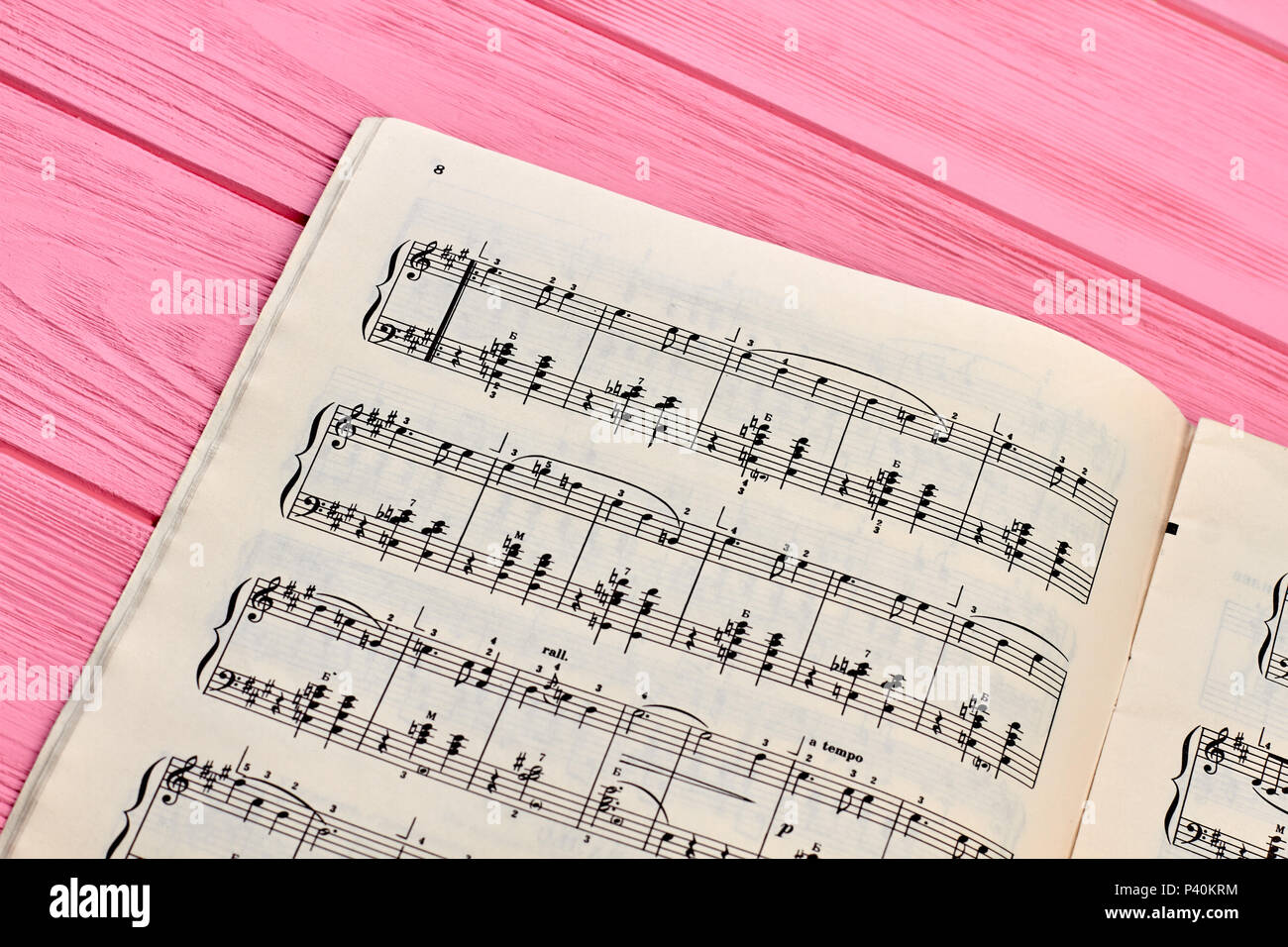 Close up sheets with musical notes. Paper with music notes on pink ...