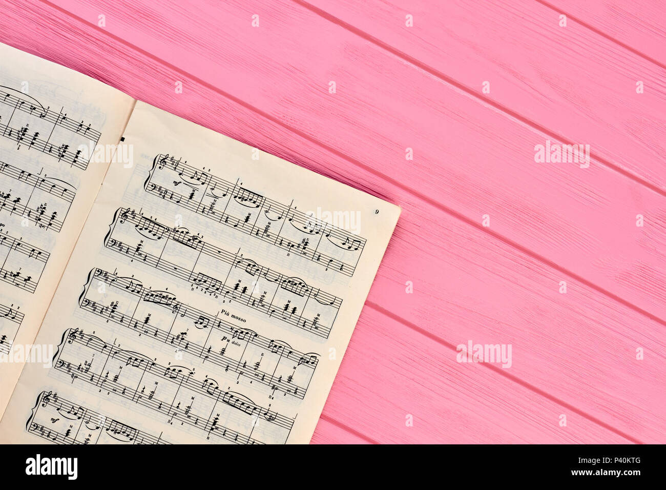 Sheet with musical notes, copy space. Paper with music notes on pink ...