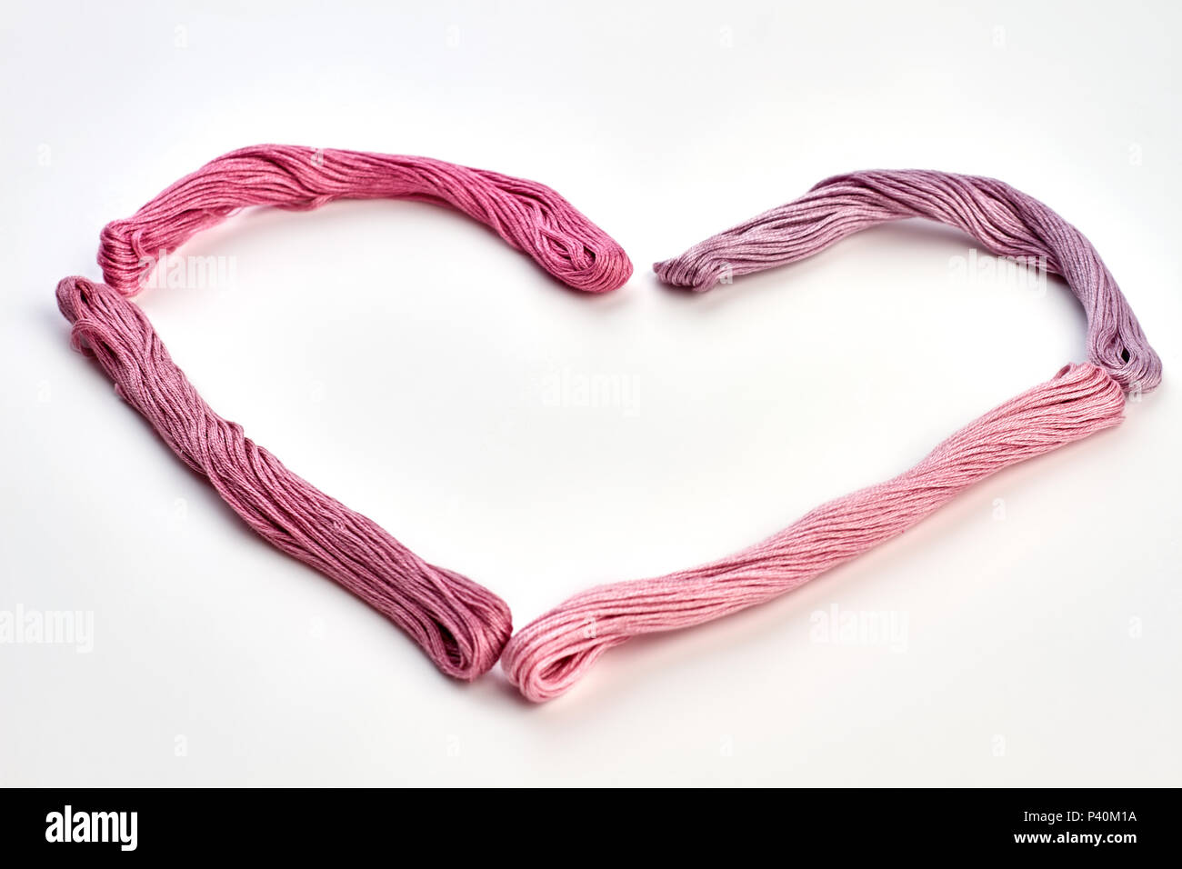 Heart shape from colorful embroidery threads. Pink threads forming ...