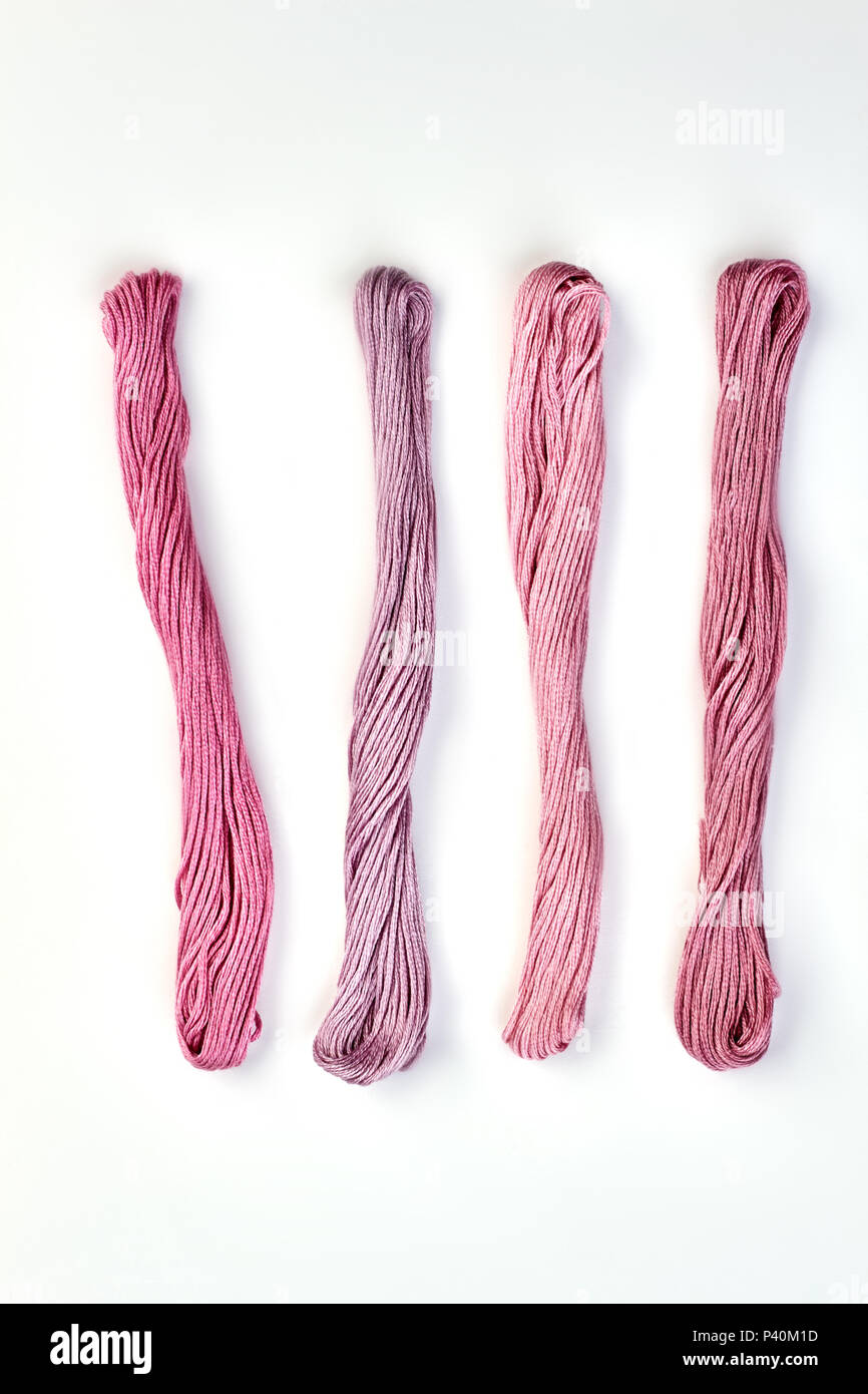 Row of pink color threads, top view. Colorful embroidery threads in ...