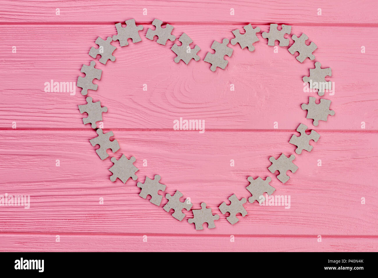 Puzzle pieces forming heart frame. Heart frame made from cardboard ...