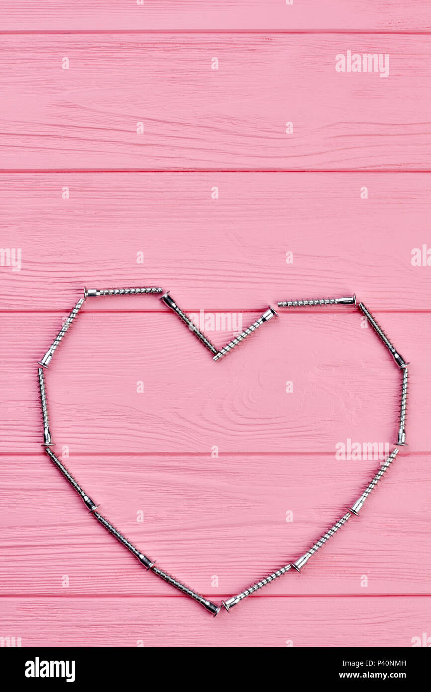 Heart shape from metal fasteners. Fasteners with zincked screws on a ...