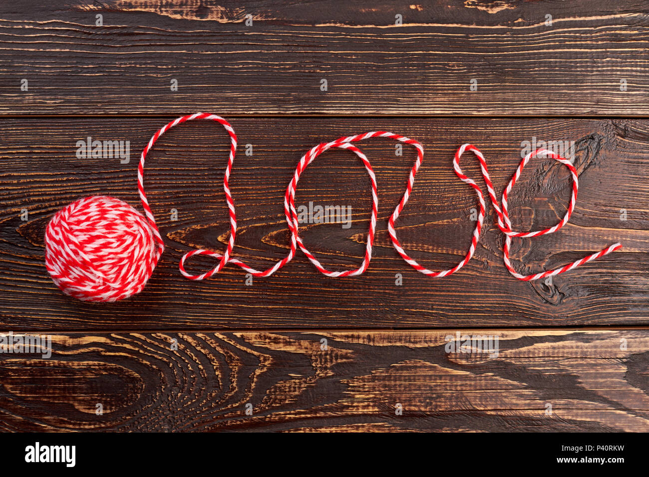 Word love written with woolen thread. Ball of yarn and text love. Happy ...