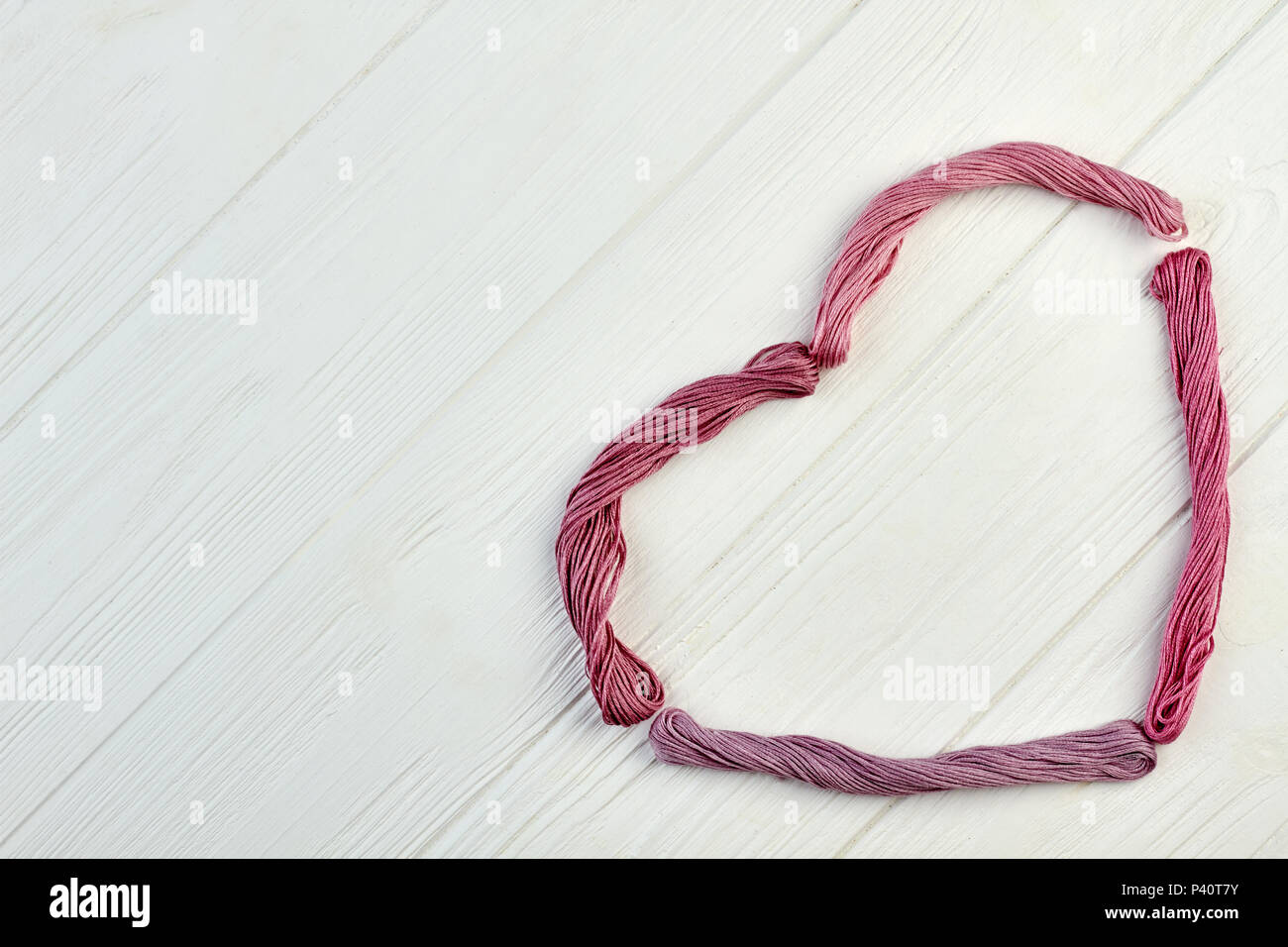 Heart from threads and copy space. Textile threads arranged in a shape ...