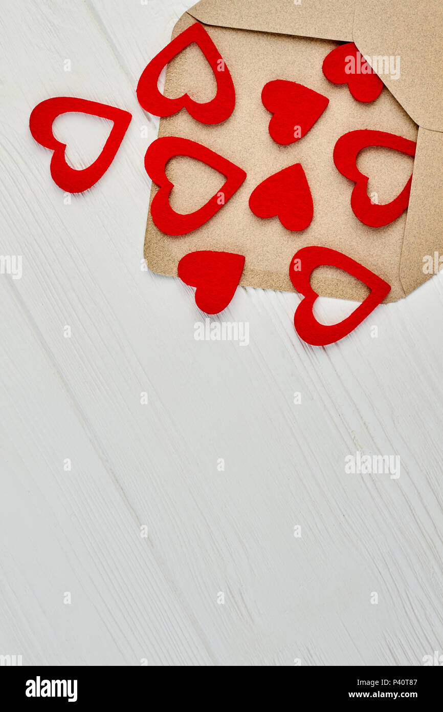 Opened envelope with hearts flying out. Envelope from craft paper with ...