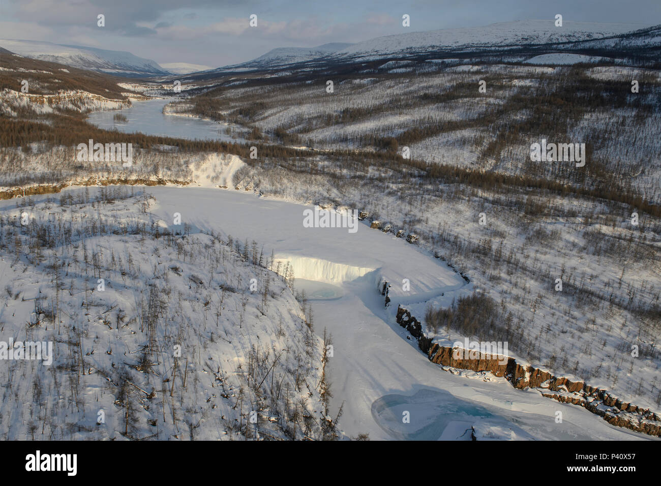 Frozen river in valley in winter, Putoransky State Nature Reserve ...