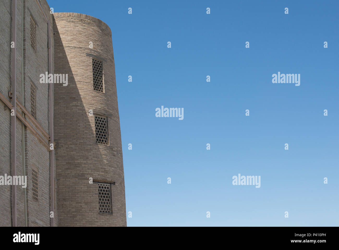 An old brick building with a tower. Ancient buildings of medieval Asia ...