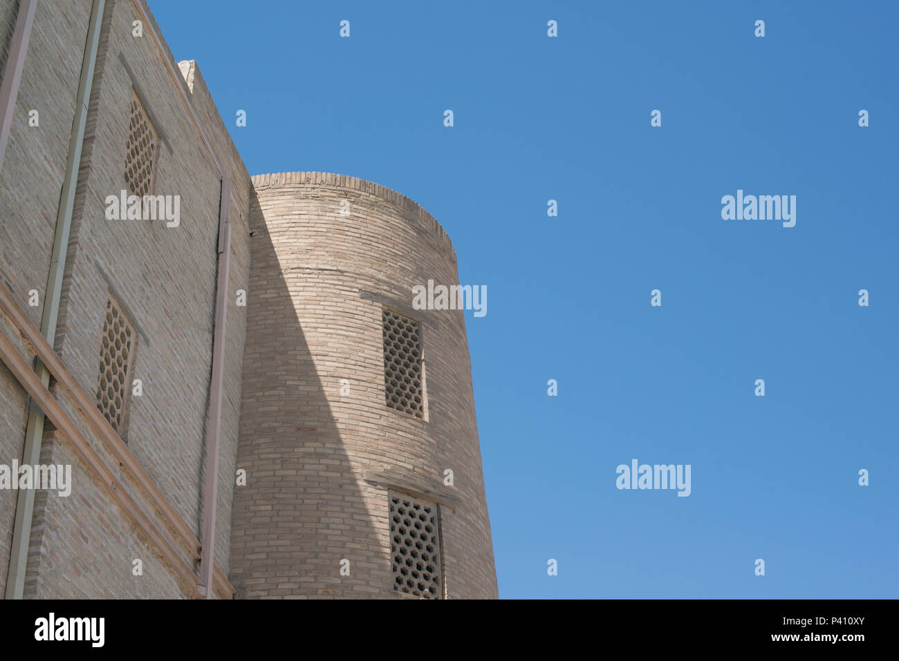 An old brick building with a tower. Ancient buildings of medieval Asia ...