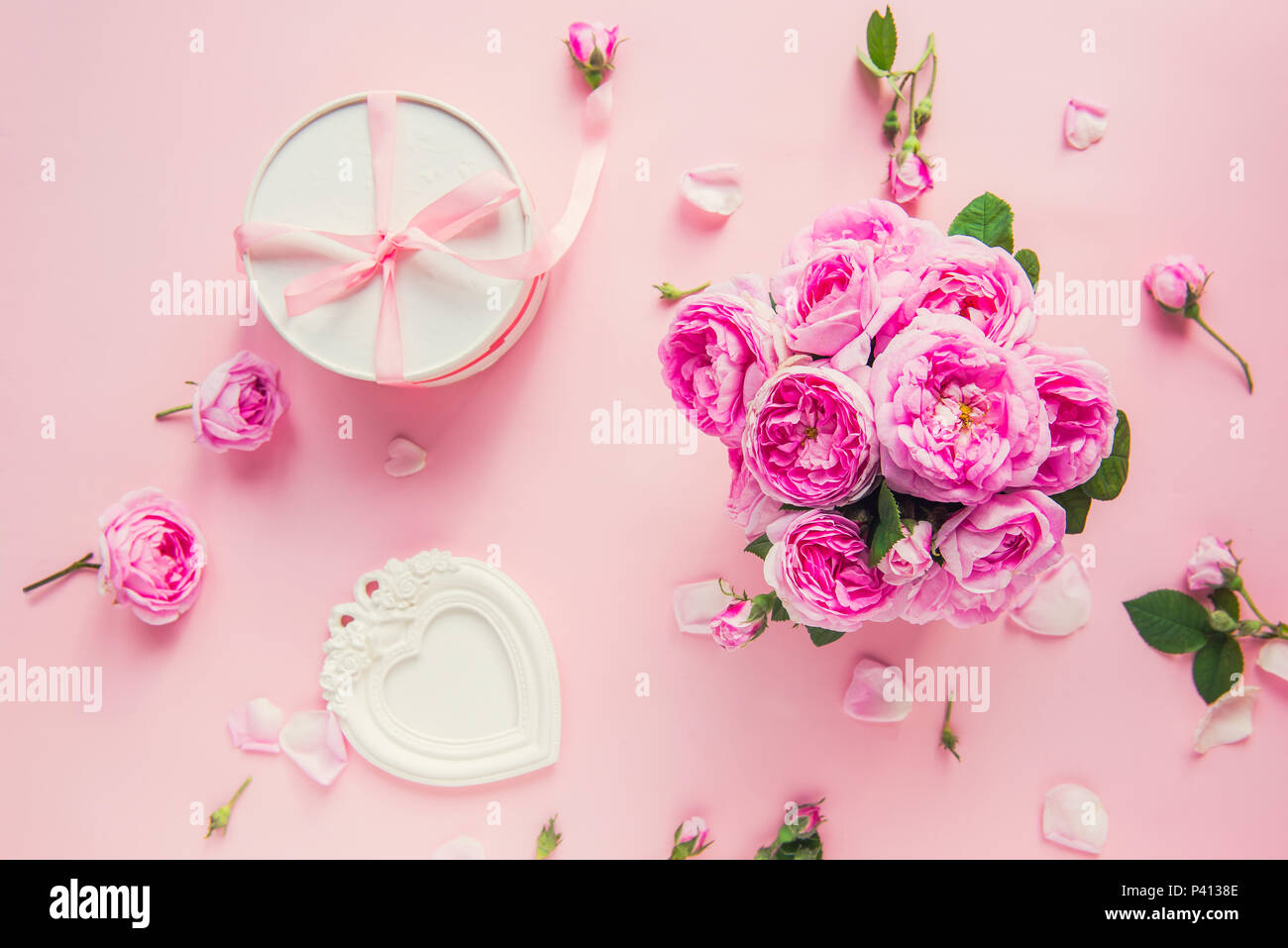 Top view pink tea roses bouquet, white round box with ribbon and ...