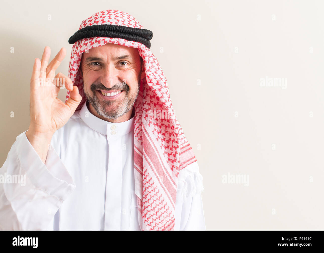 Senior arabic man doing ok sign with fingers, excellent symbol Stock ...
