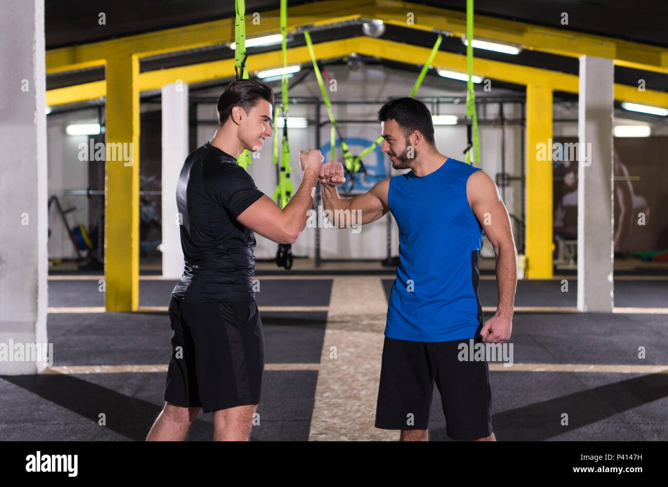 a young men athletes making high five after hard exercise at cross ...