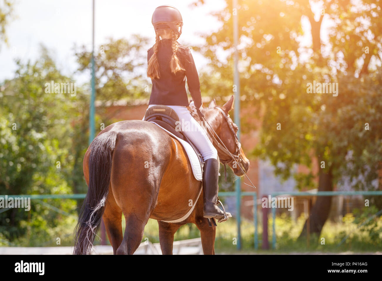 Young girl riding horse on equestrian competition. Equestrian dressage ...