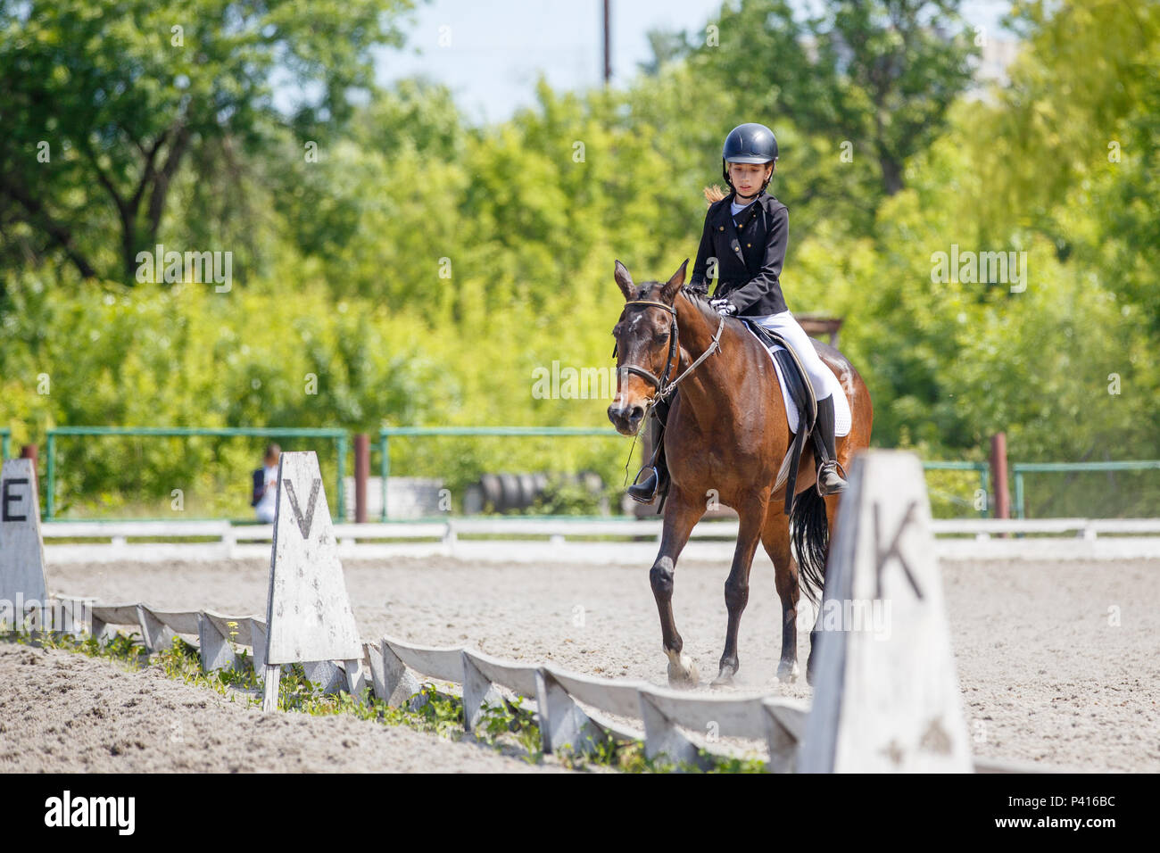 Young girl riding horse on equestrian competition. Equestrian dressage ...