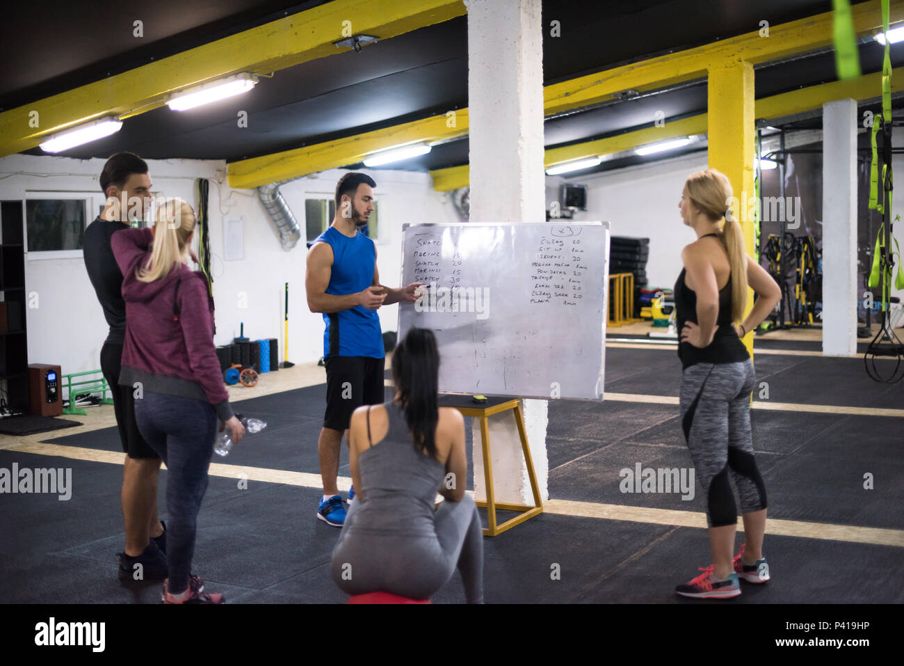 Training course.group of young athletes getting instructions from ...