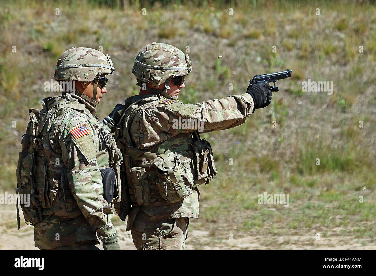 Spc. Kyle Miller (right), a cannon crewmember assigned to B Battery ...