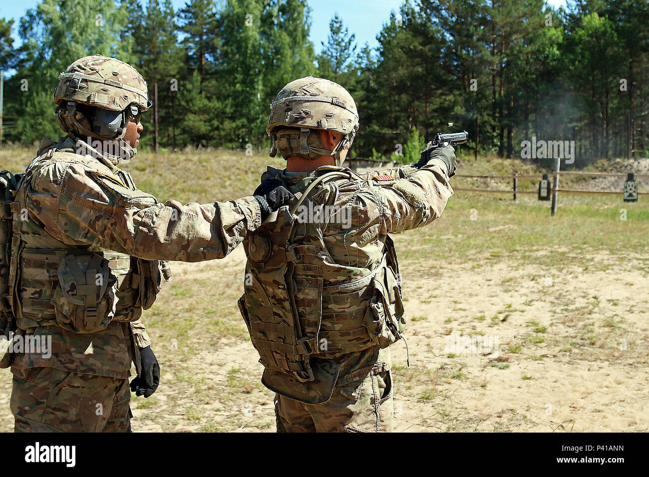 Pfc. Austin Piette (rght), a cannon crewmember assigned to B Battery ...