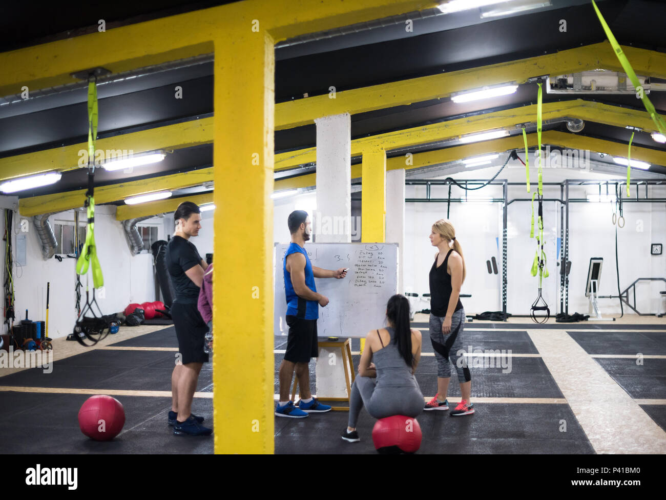 Training course.group of young athletes getting instructions from ...