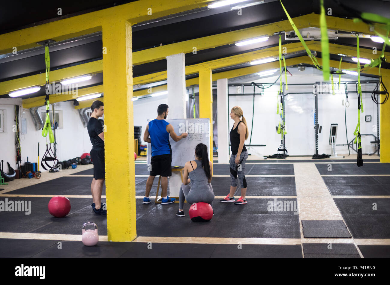 Training course.group of young athletes getting instructions from ...