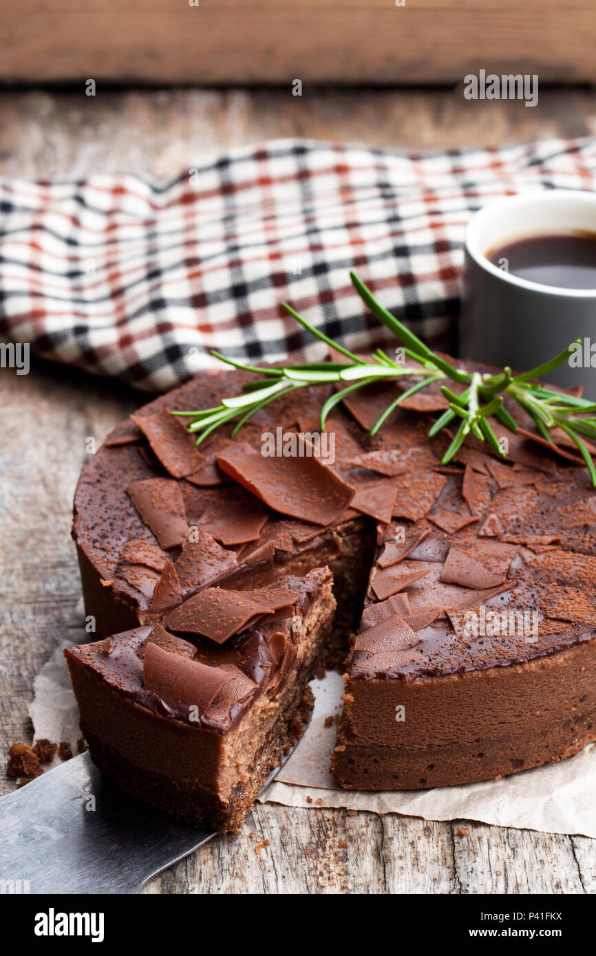 Baked belgian chocolate cheesecake with chocolate ganache on wooden ...