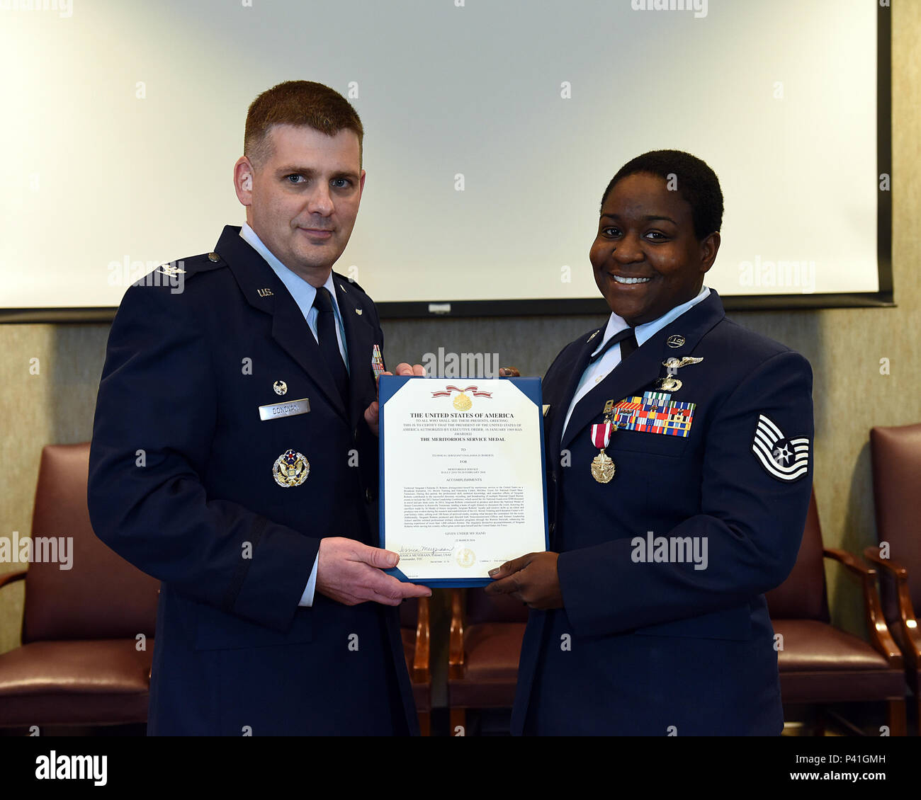 Tech. Sgt. Chalanda D. Roberts is presented the Meritorious Service ...
