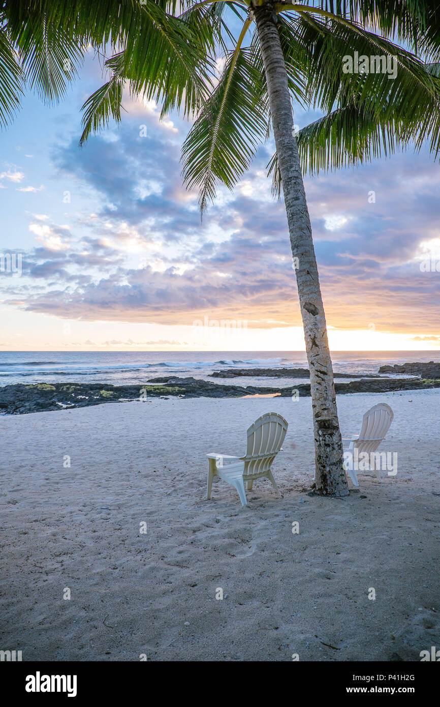 Two deck chairs under palm tree on an empty beach at Lefaga, Matautu ...