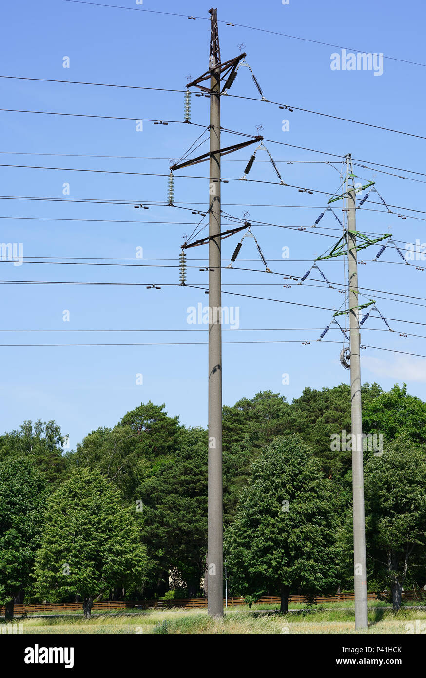 high-voltage power line metal props over cloudless blue sky Stock Photo ...