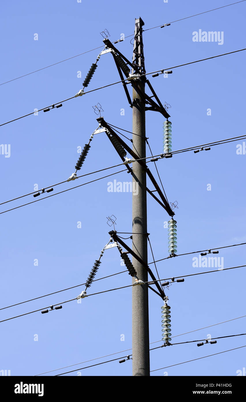 high-voltage power line metal props over cloudless blue sky Stock Photo ...