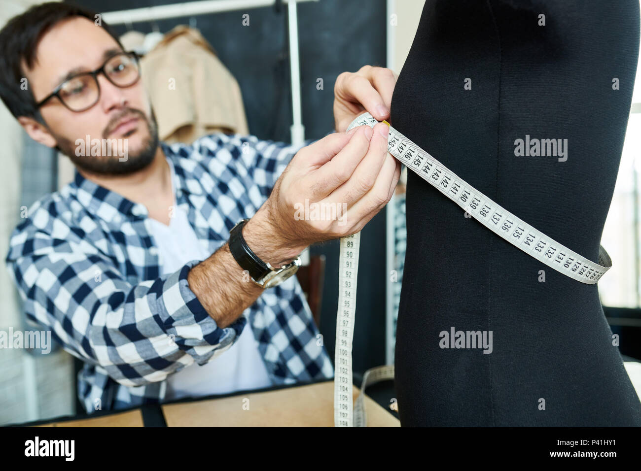 Man designing dress with mannequin Stock Photo - Alamy