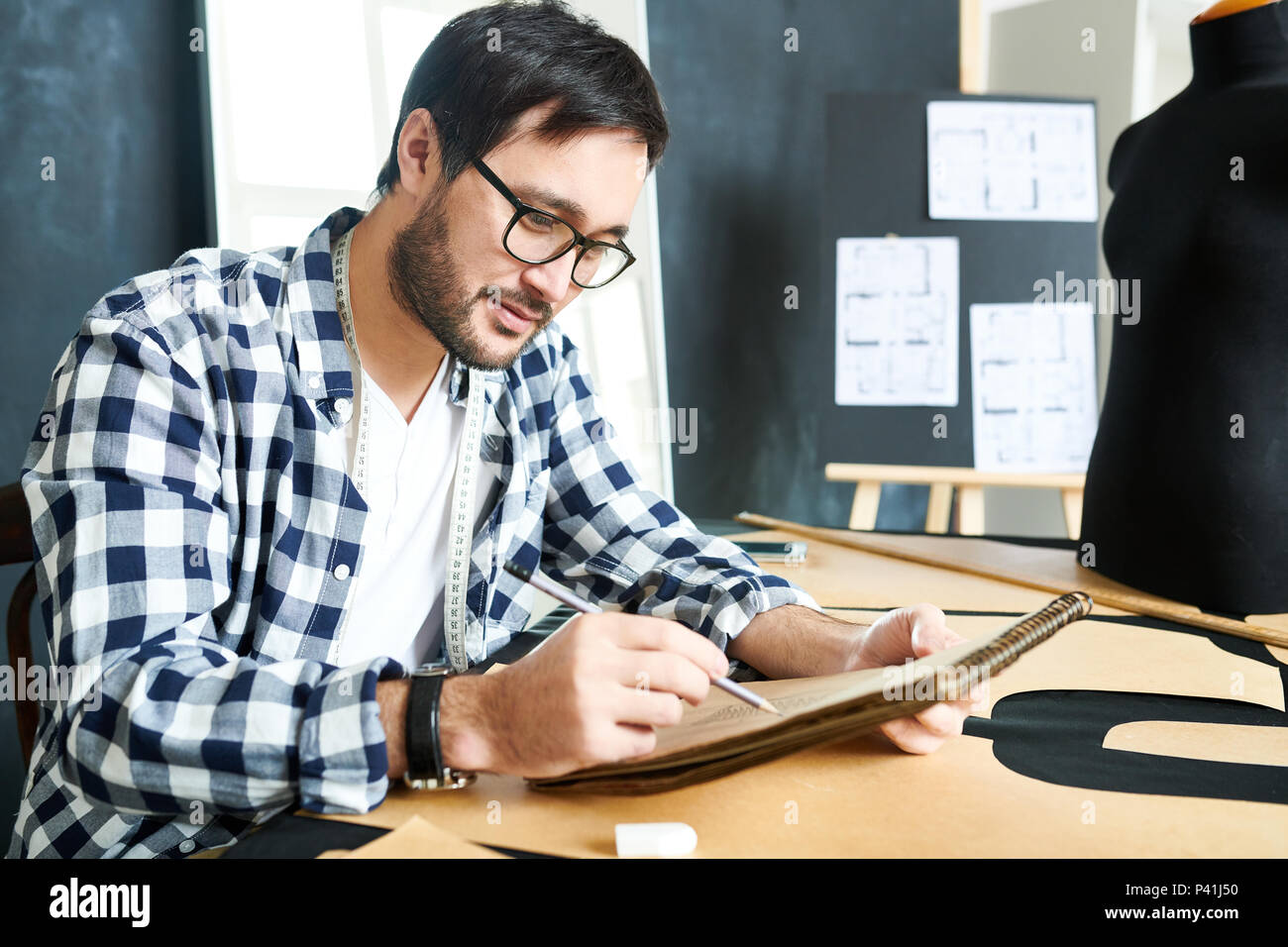Inspired man making dress design Stock Photo - Alamy