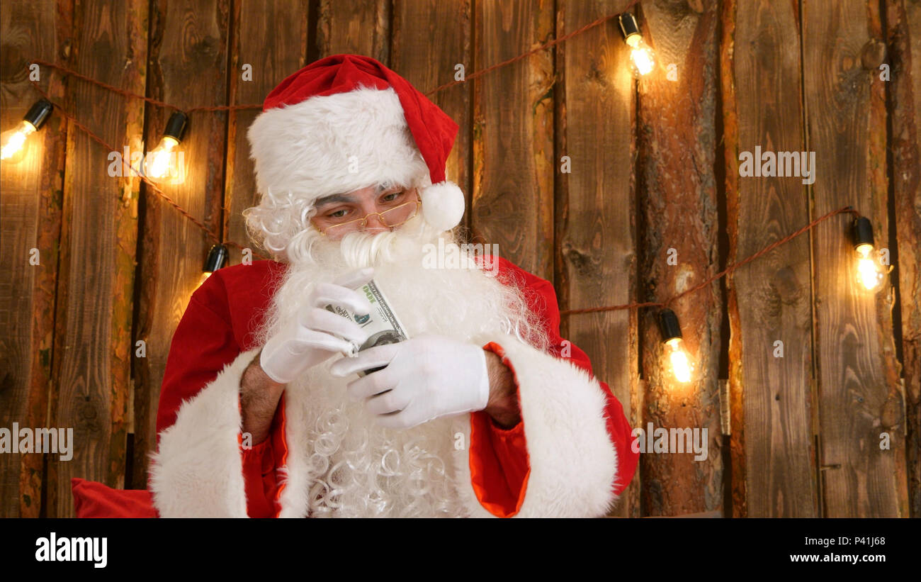 Santa Claus counting his money and showing money disappearing trick ...