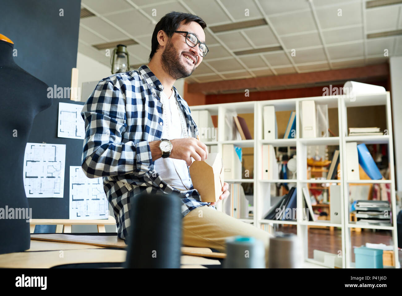 Content man having meal in studio Stock Photo - Alamy
