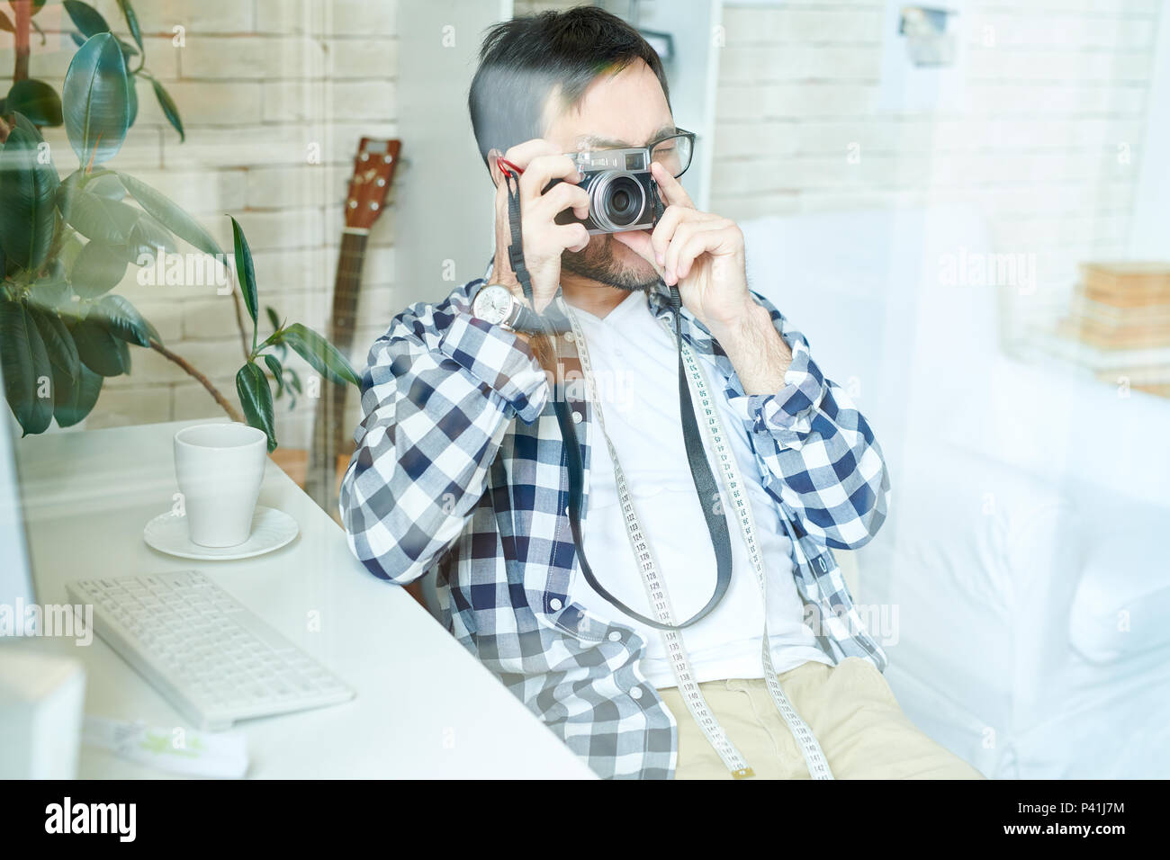 Creative designer using photo camera Stock Photo - Alamy