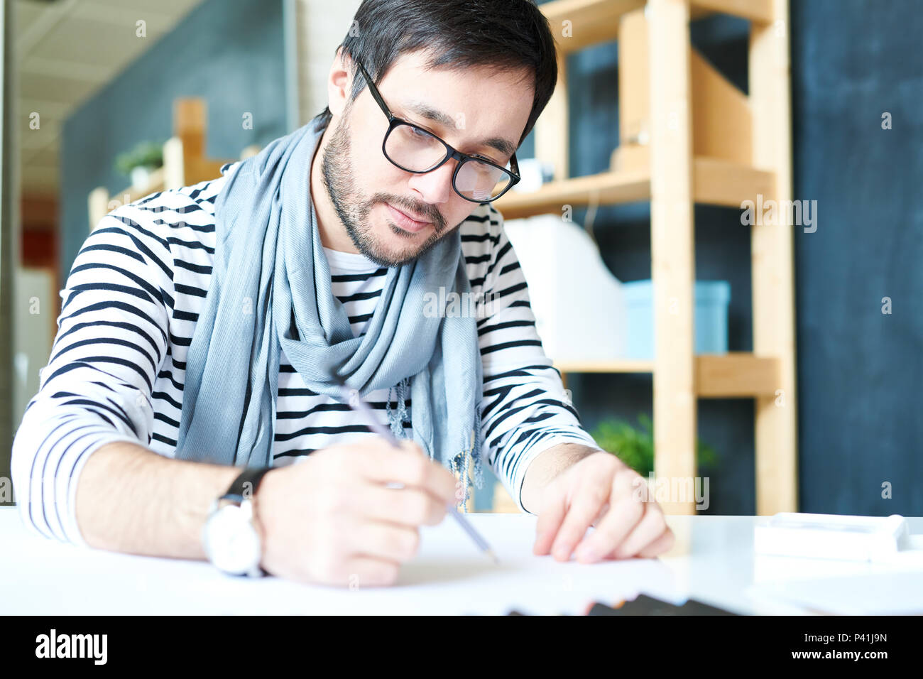 Inspired man drawing sketches Stock Photo - Alamy