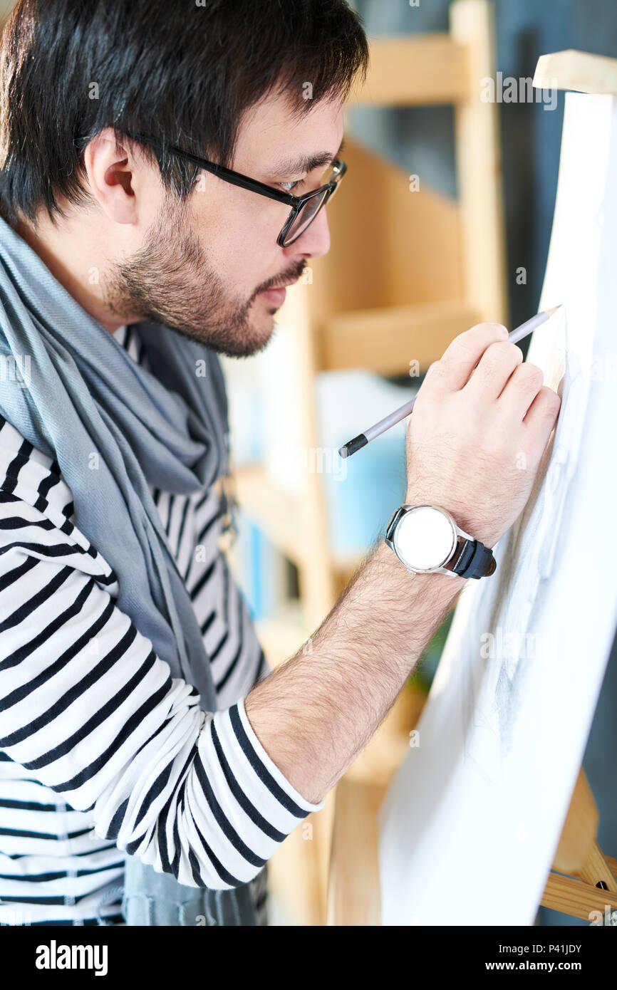 Man drawing with pencil on easel Stock Photo - Alamy