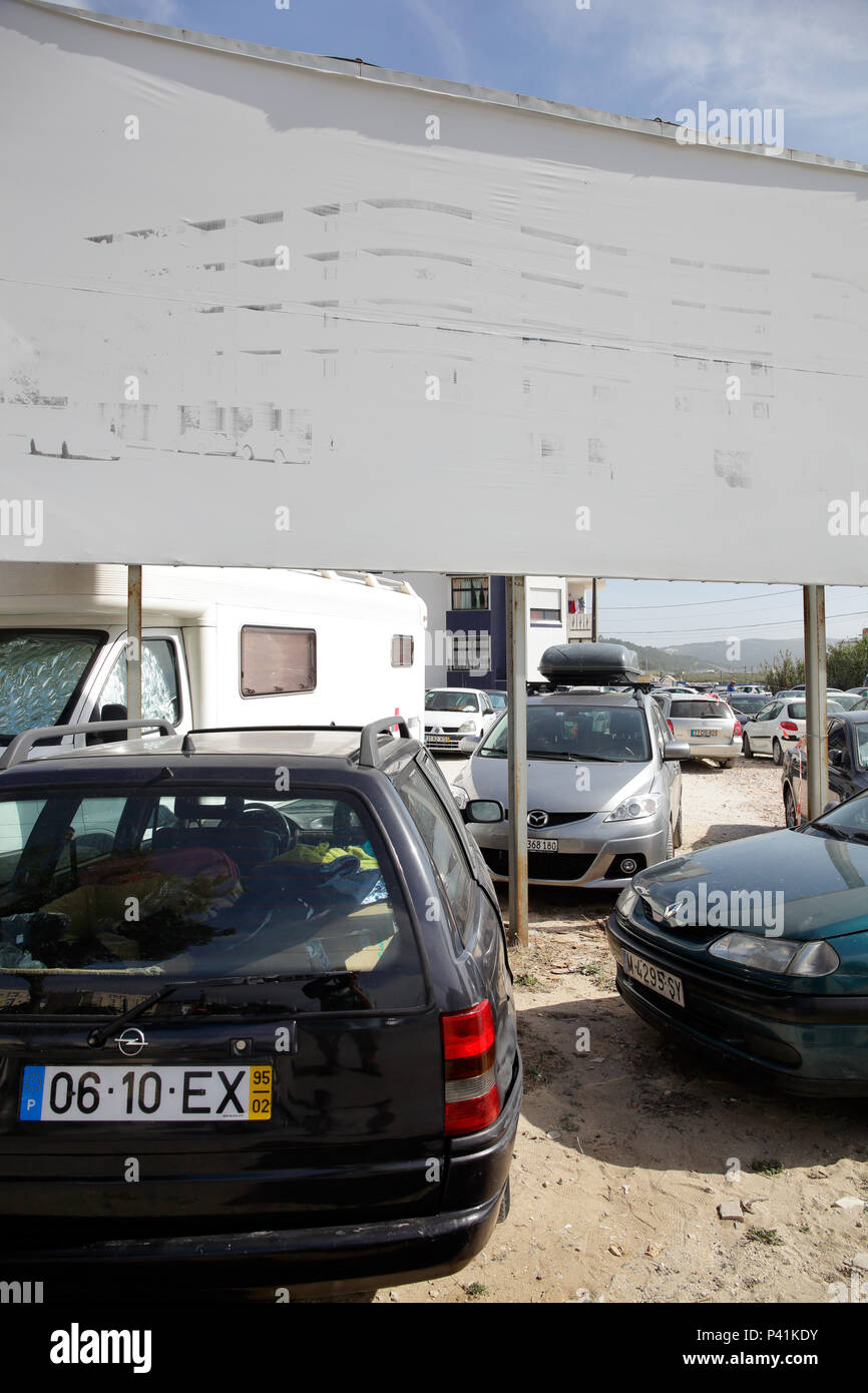 Nazare, Portugal, Faded construction sign and parked cars on a parking ...