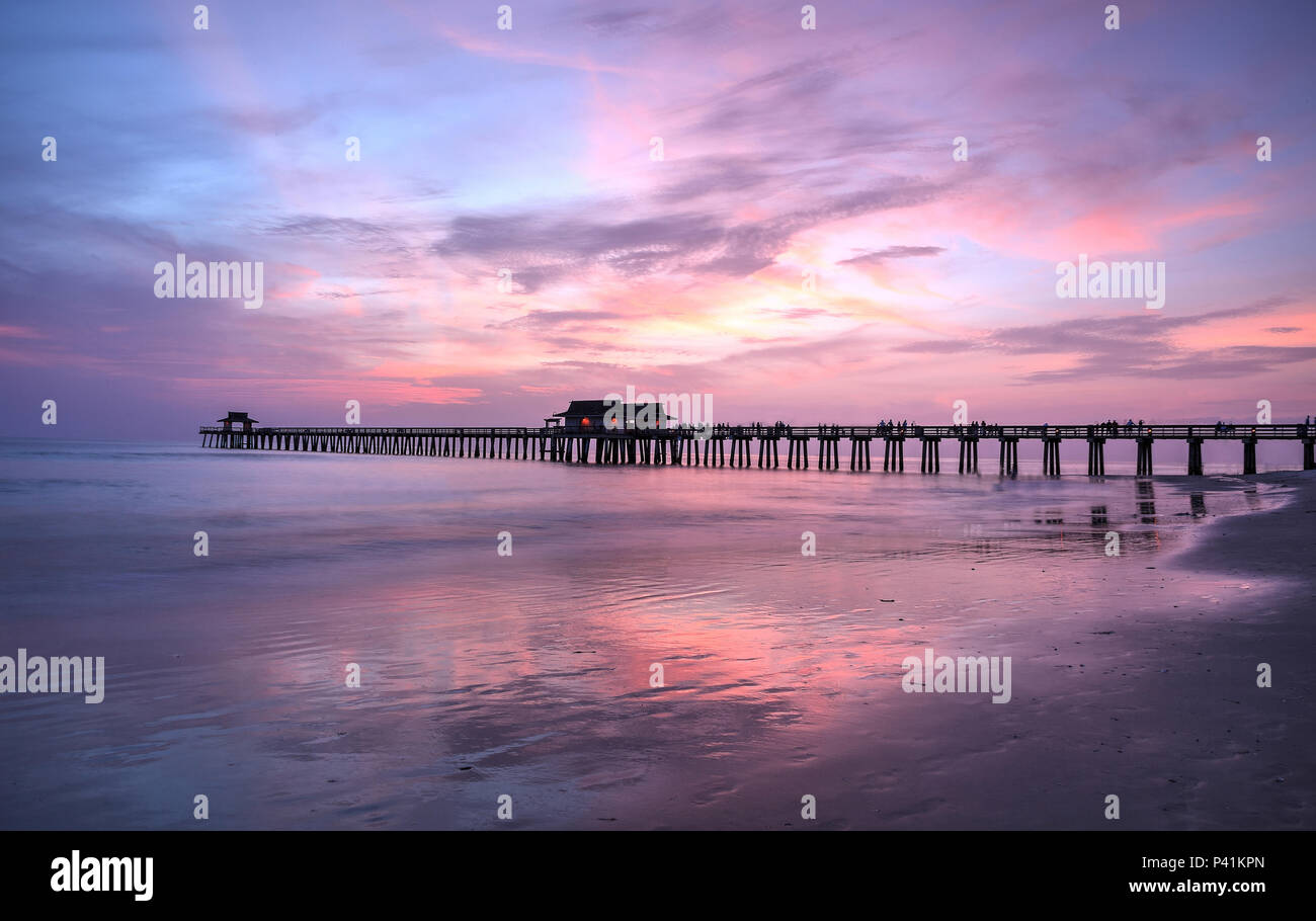 Pink and purple sunset over the Naples Pier in summer in Naples ...